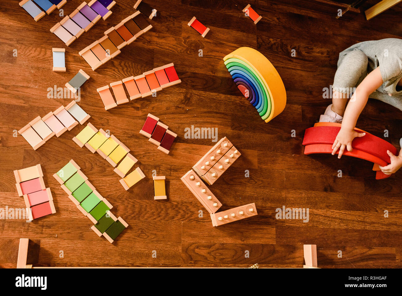 Children playing with wooden rainbow waldorf montessori Stock Photo - Alamy
