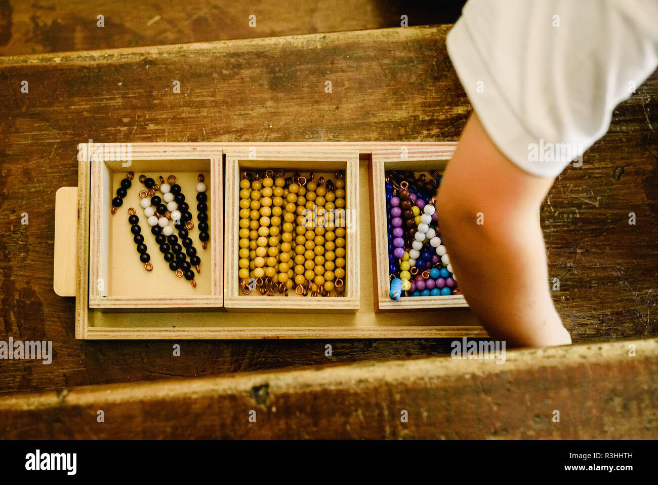 Hands of a child manipulating educational materials to learn to count ...