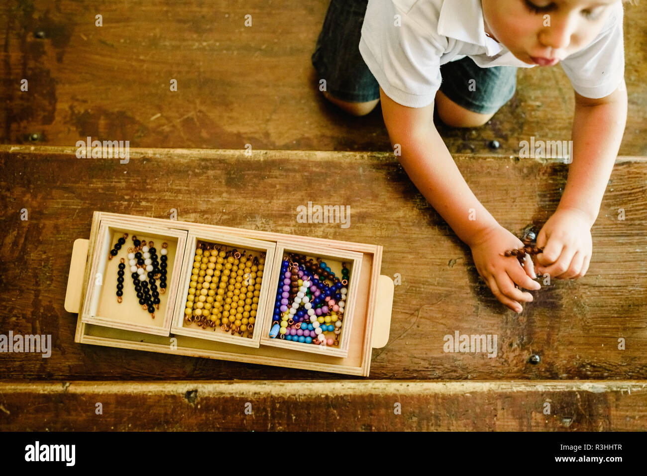 Hands of a child manipulating educational materials to learn to count ...
