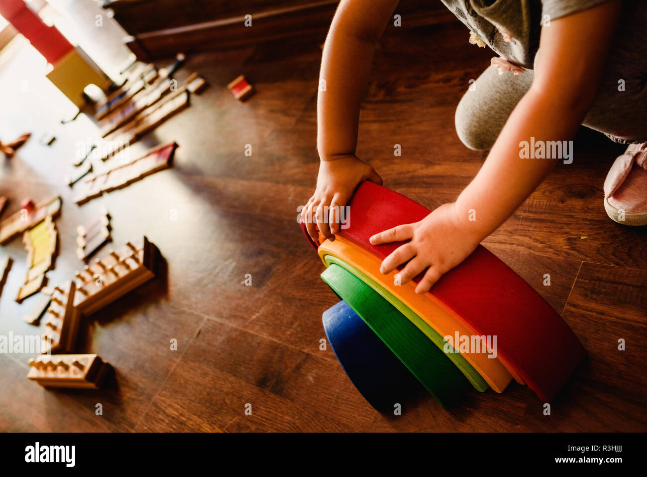 Children playing with wooden rainbow waldorf montessori Stock Photo - Alamy