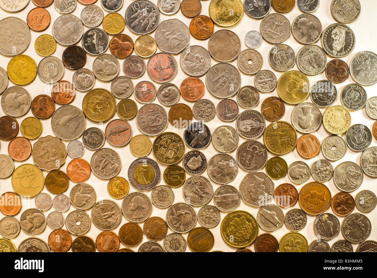 Many coins from different countries of the world Stock Photo - Alamy