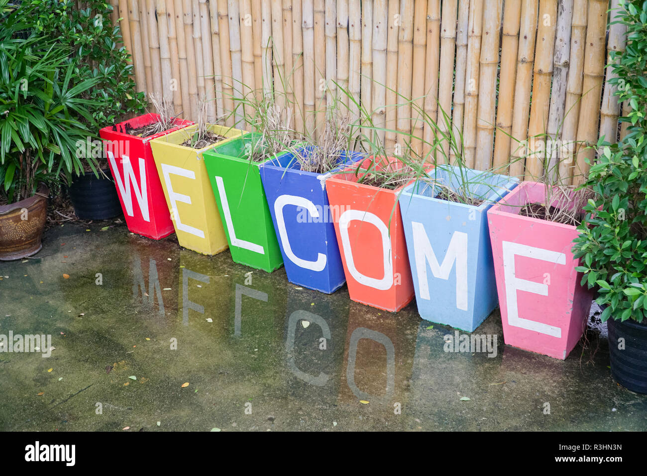 welcome text on pot bamboo wall background Stock Photo - Alamy