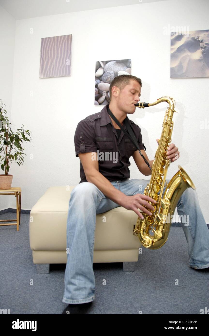 Playing saxophone at home hi-res stock photography and images - Alamy