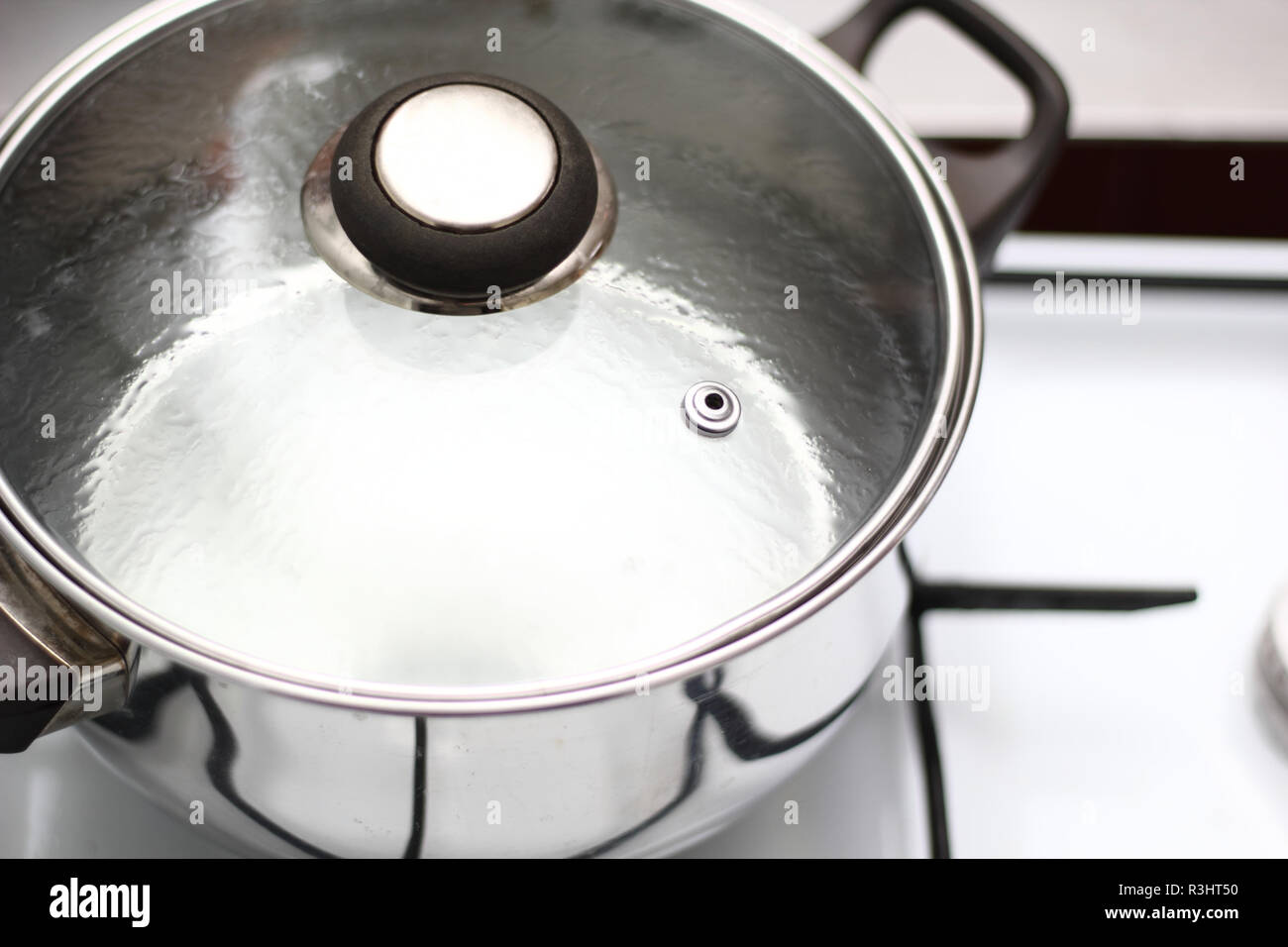 Sauce Pot with Glass Lid with boiling water Stock Photo - Alamy