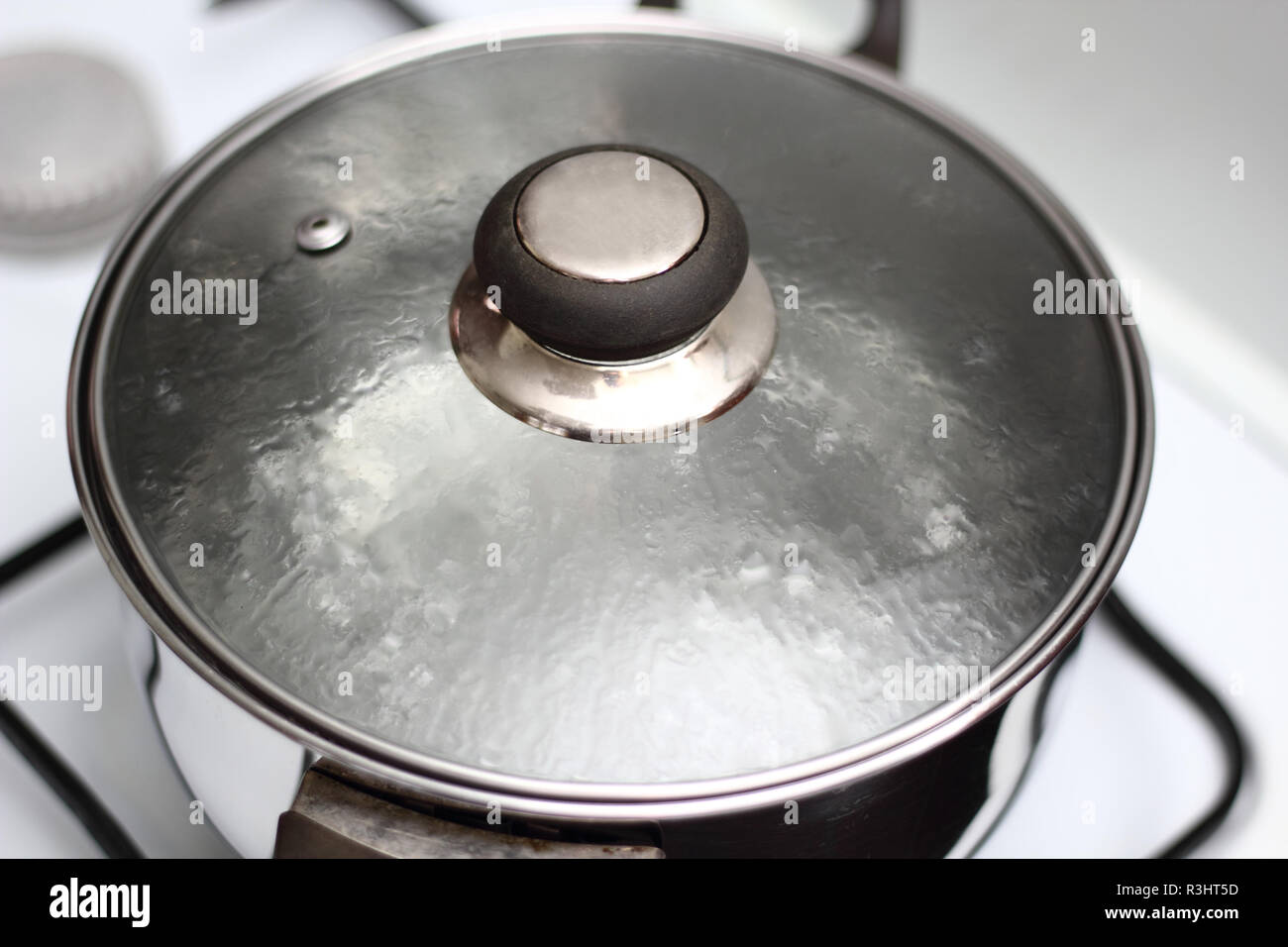 Sauce Pot with Glass Lid with boiling water Stock Photo - Alamy