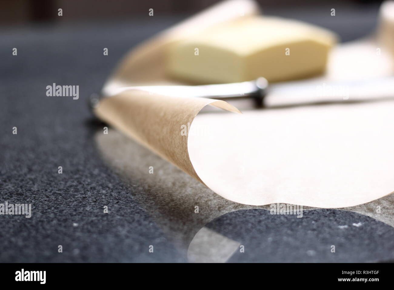 Block butter on parchment paper amd table knife Stock Photo - Alamy