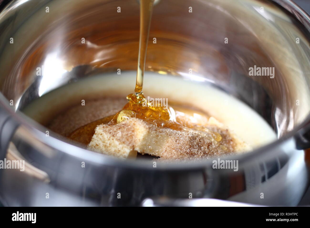 Adding golden syrup into pan with filling ingredients. Making Boston ...