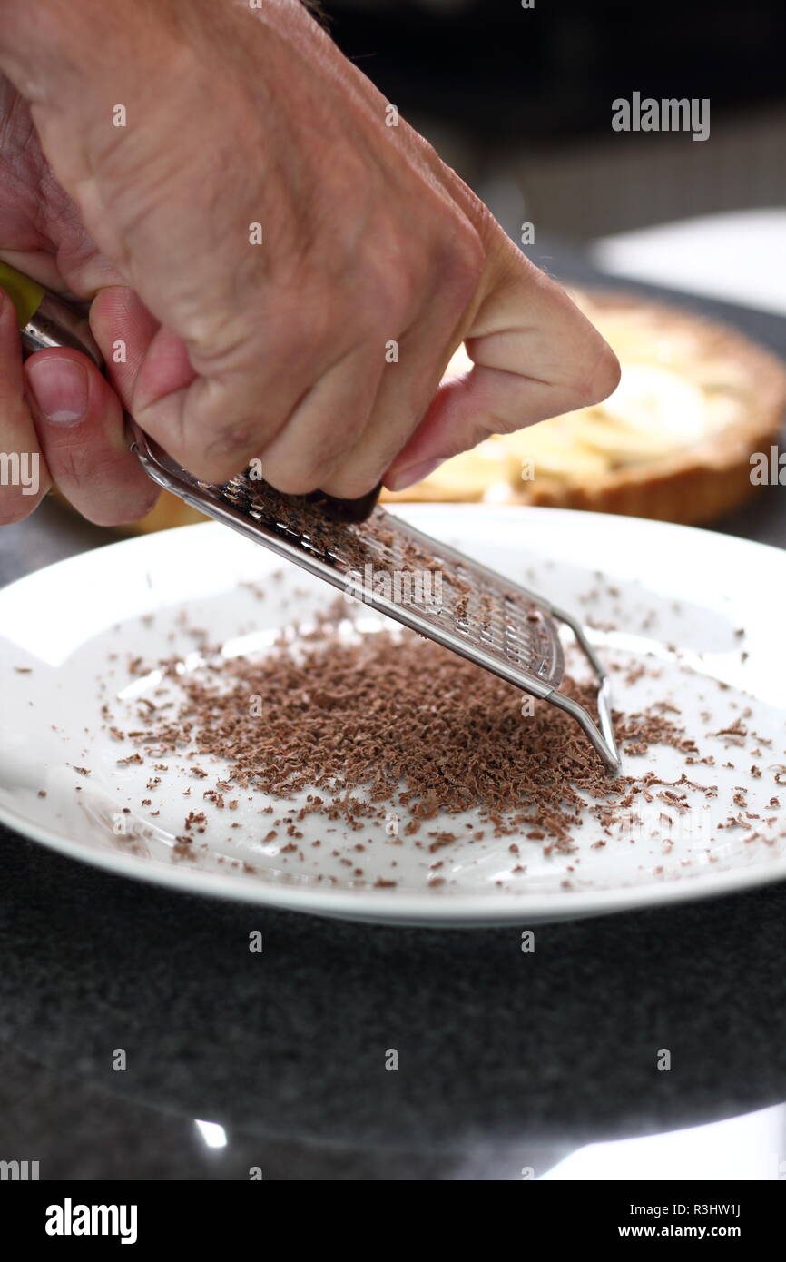 Grate Chocolate Bar Using Handheld Grater. Making Boston Banoffee Pie ...