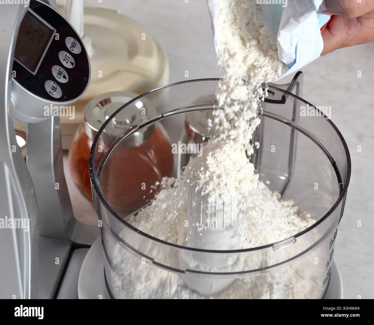 Pouring flour into mixer. Making Treacle Pie Series Stock Photo - Alamy