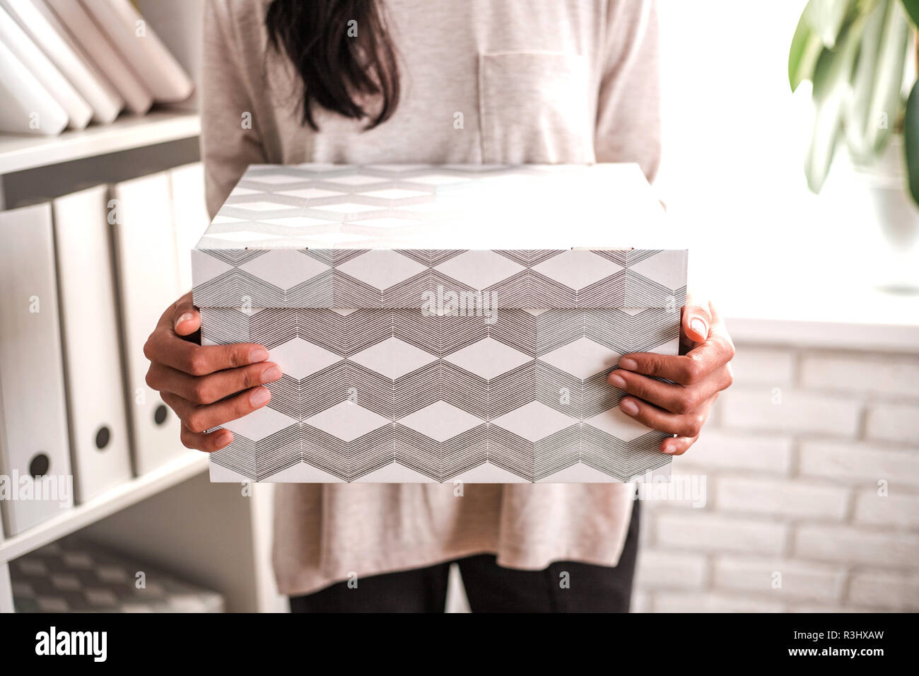 Woman with a cardboard box in hand Stock Photo - Alamy