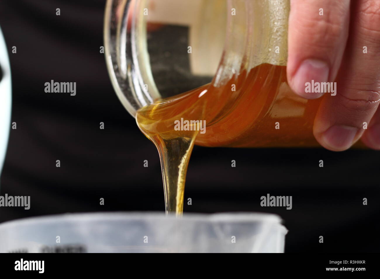 Pouring golden syrup into measuring cup. Making Shoofly Tart Series ...
