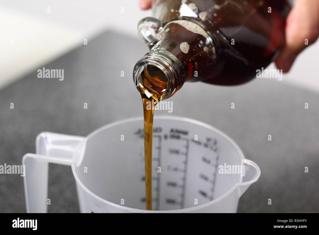 Pouring Maple Syrup into Measuring Cup. Making Cider Pie Series Stock ...