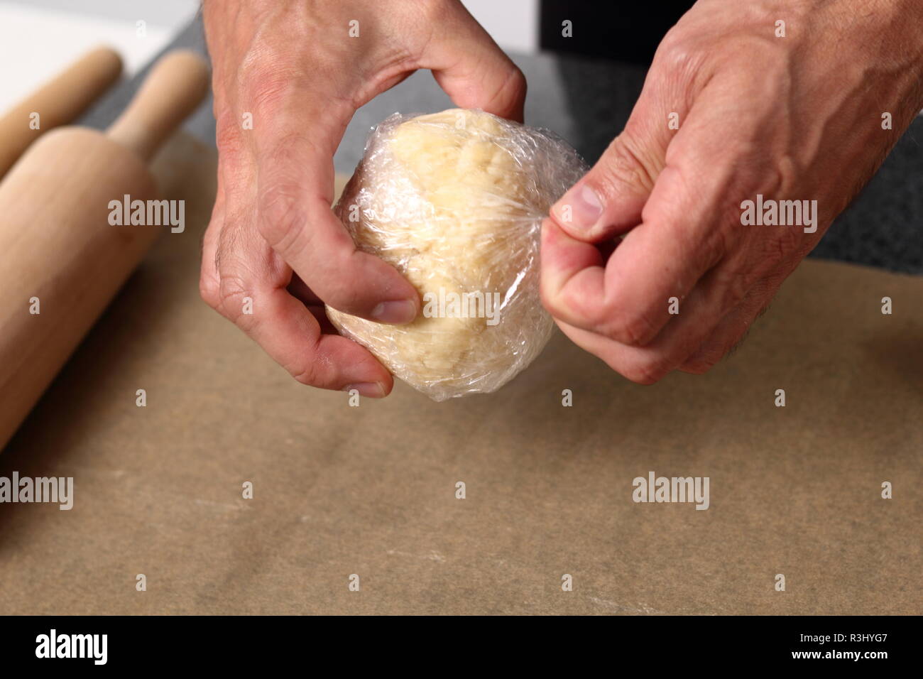 Unwrapping dough ball from plastic film. Making Cider Pie Series Stock ...