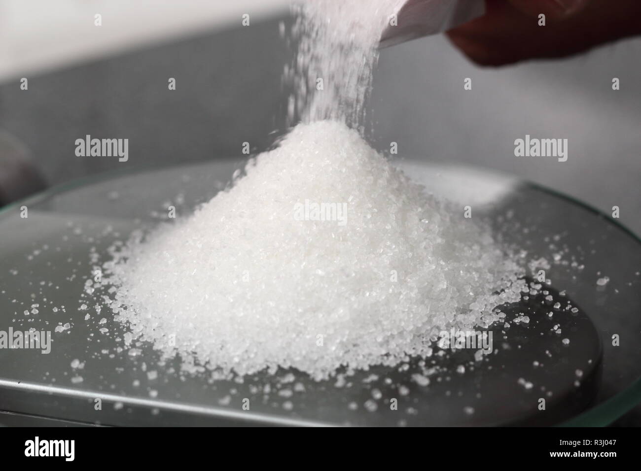 Weighing sugar on kitchen scale. Making Golden Syrup Series Stock Photo ...