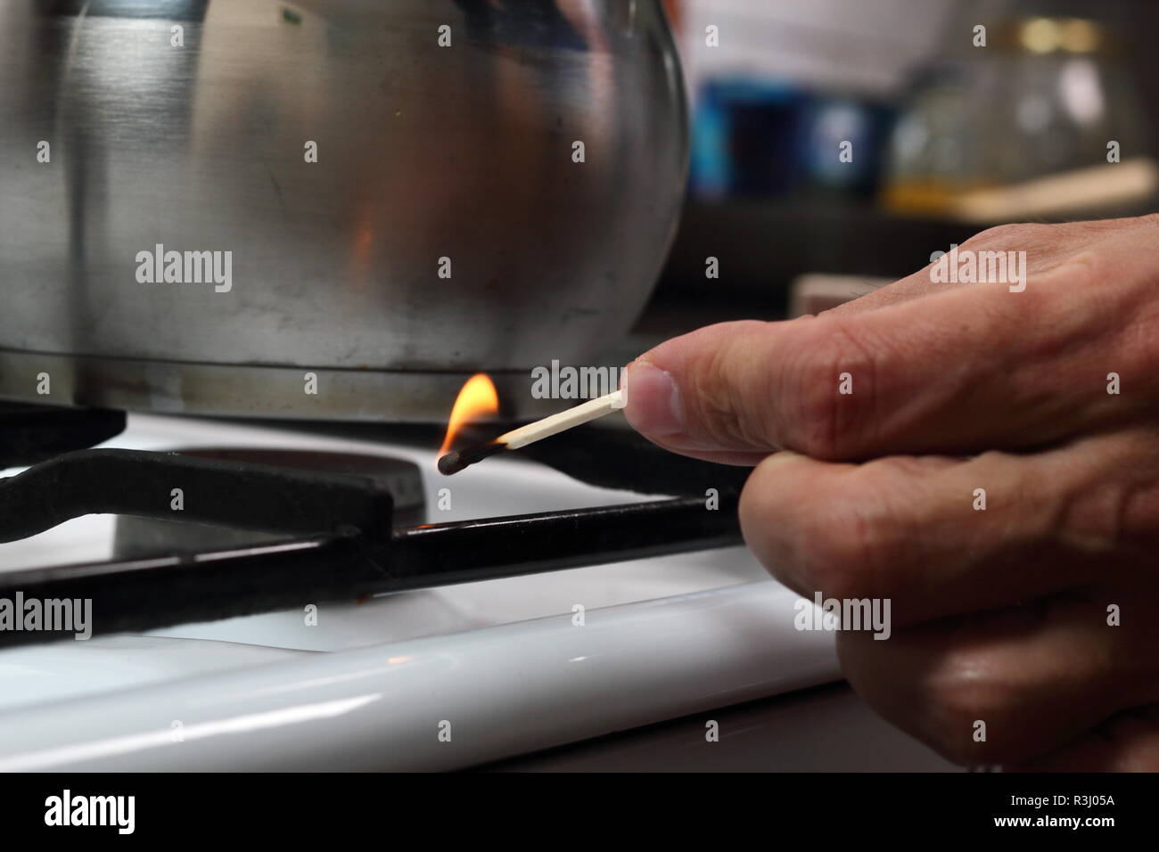 Chef lights gas stove with match. Making Golden Syrup Series Stock ...