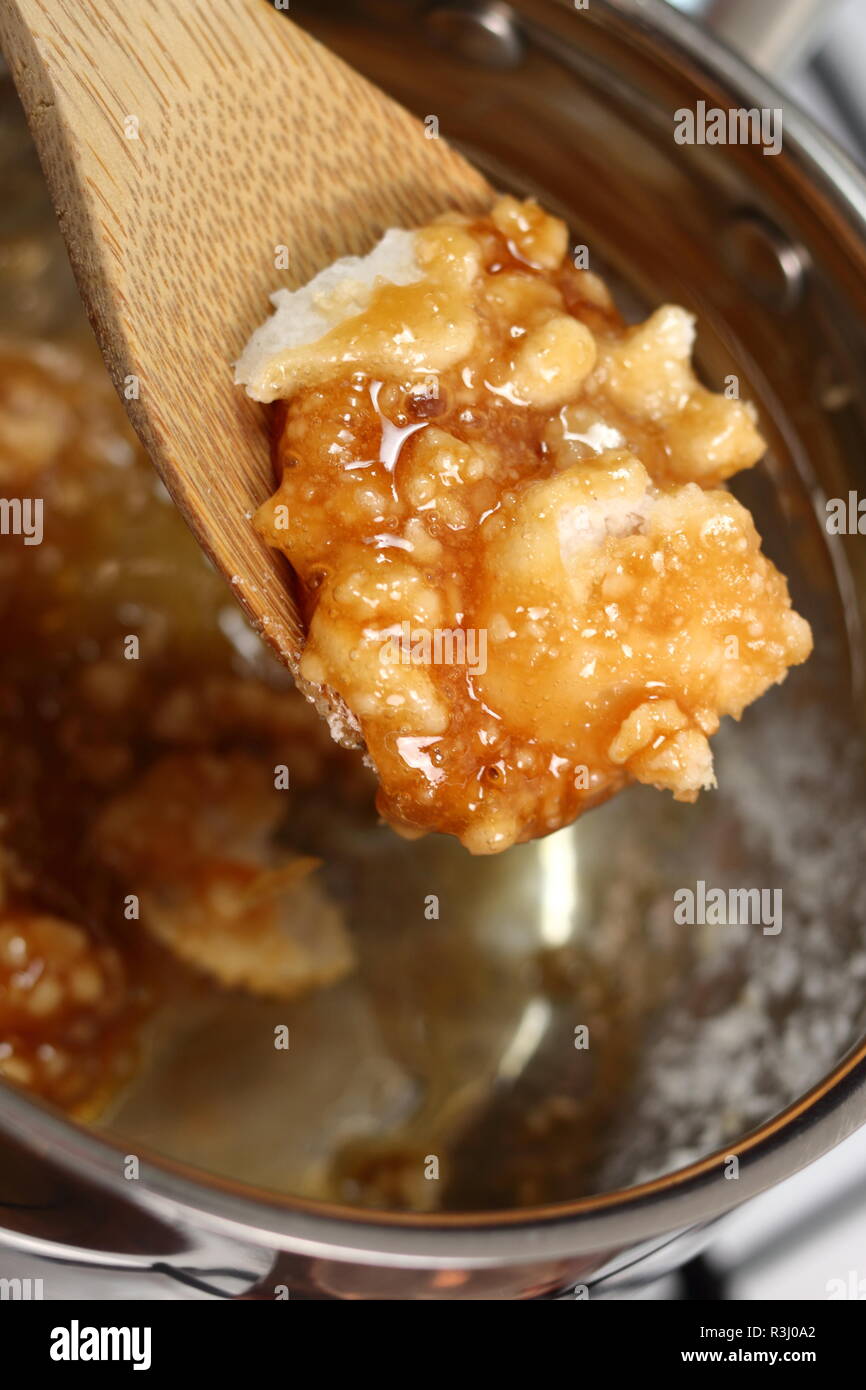Melting and caramelize sugar in saucepan Stock Photo - Alamy