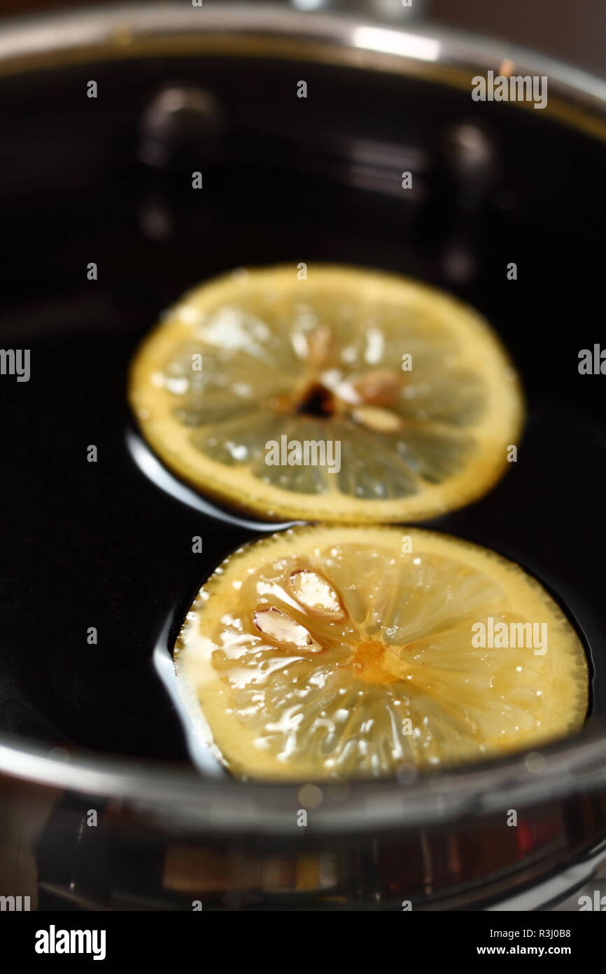 Lemon slices in black treacle syrup Stock Photo - Alamy