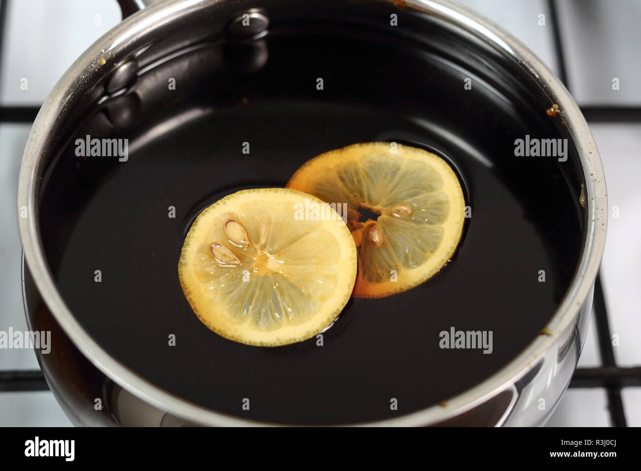 Lemon slices in black treacle syrup Stock Photo - Alamy
