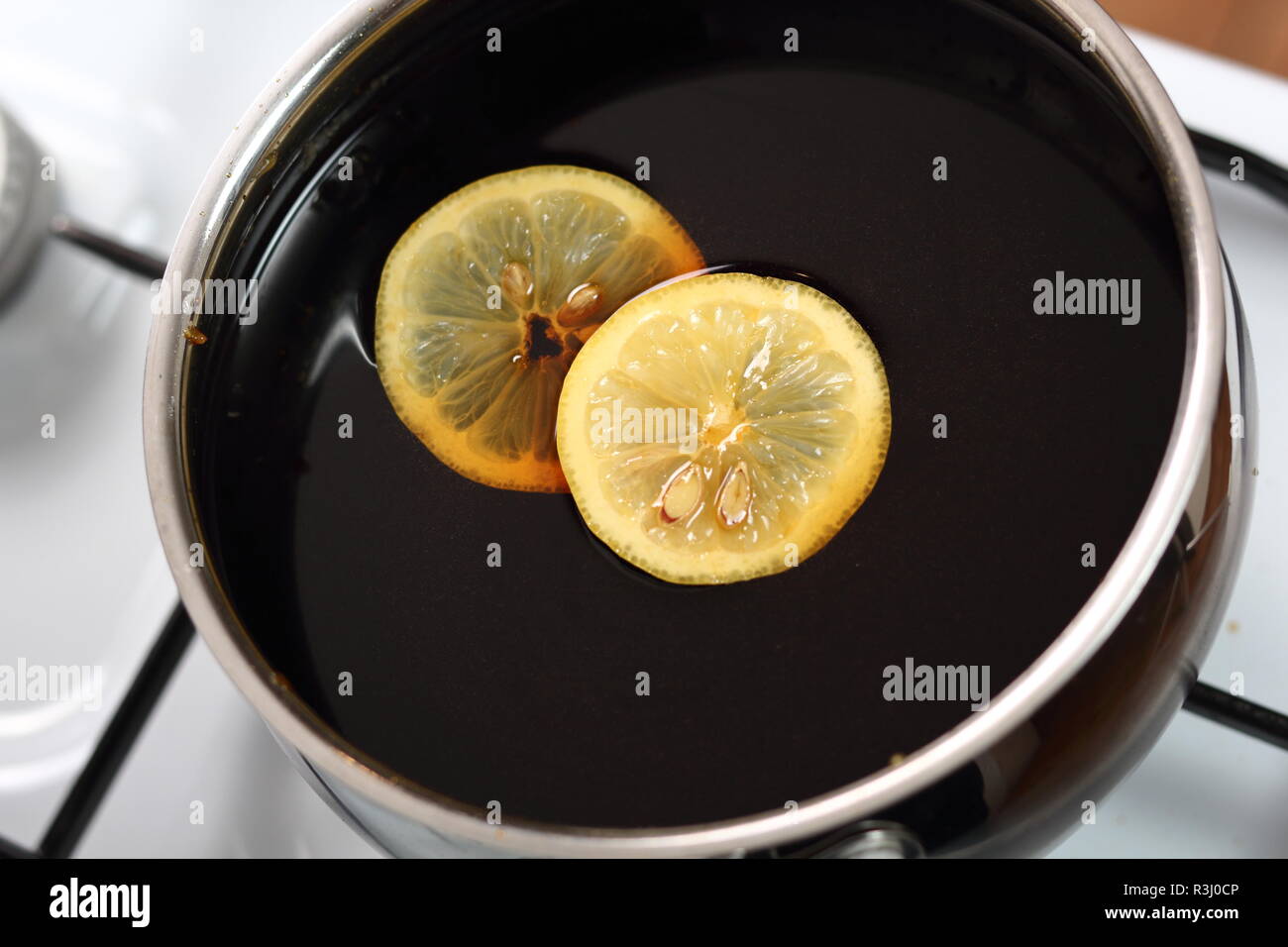 Lemon slices in black treacle syrup Stock Photo - Alamy