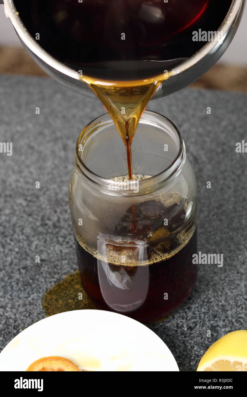 Pouring Treacle Syrup into Jar Stock Photo - Alamy