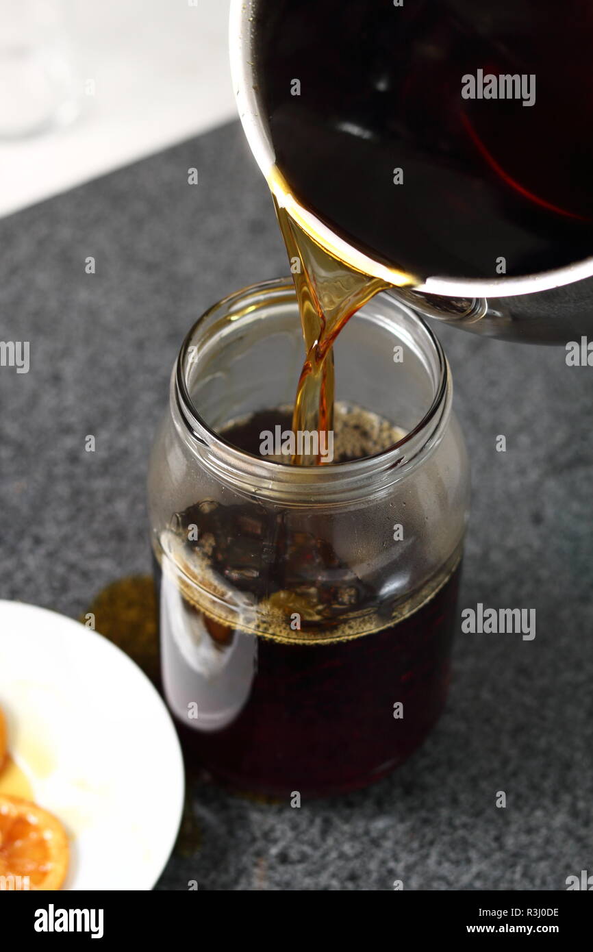 Pouring syrup into sterilised jars. Making Golden Syrup Series Stock ...