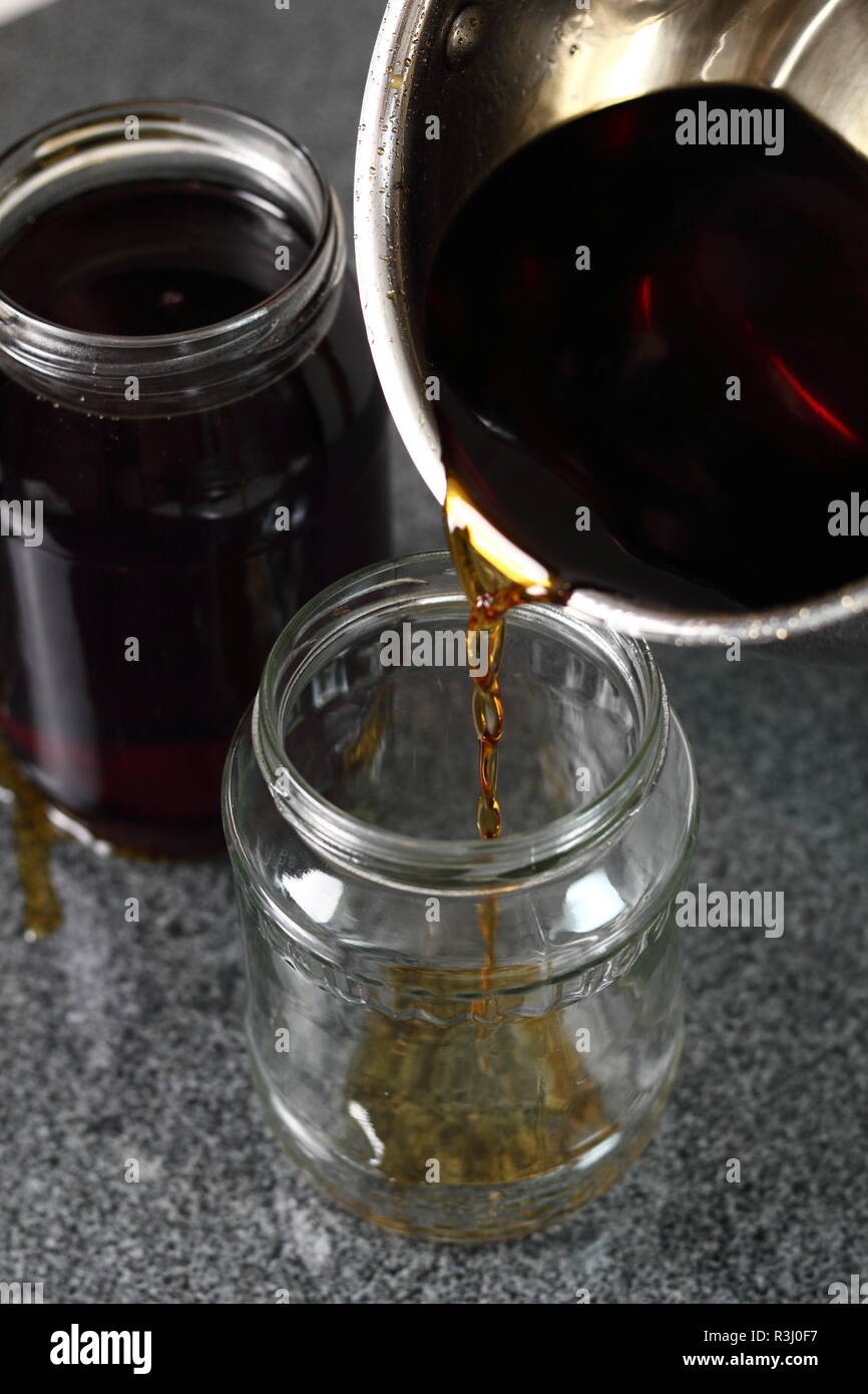 Pouring Black Treacle Syrup into Jars Stock Photo - Alamy