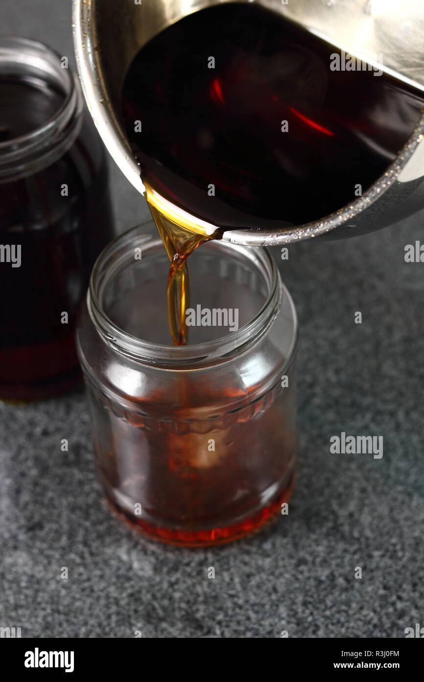 Pouring Black Treacle Syrup into Jars Stock Photo - Alamy