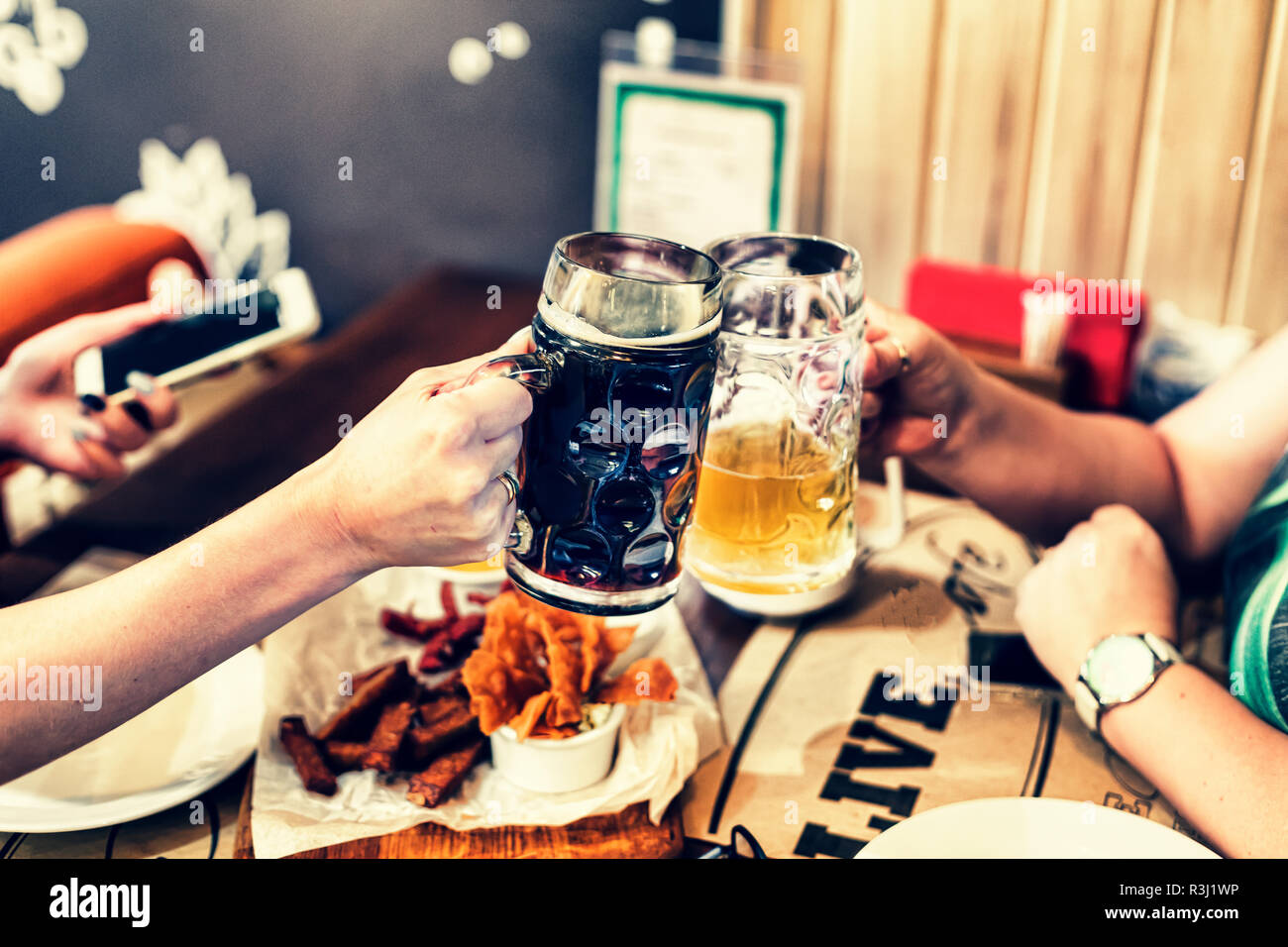 Alcohol. Beer. two man cheers and clinking glass of beer drinking and ...