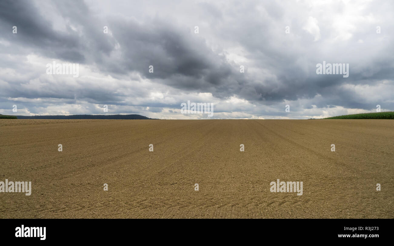fenced field with dark clouds Stock Photo - Alamy