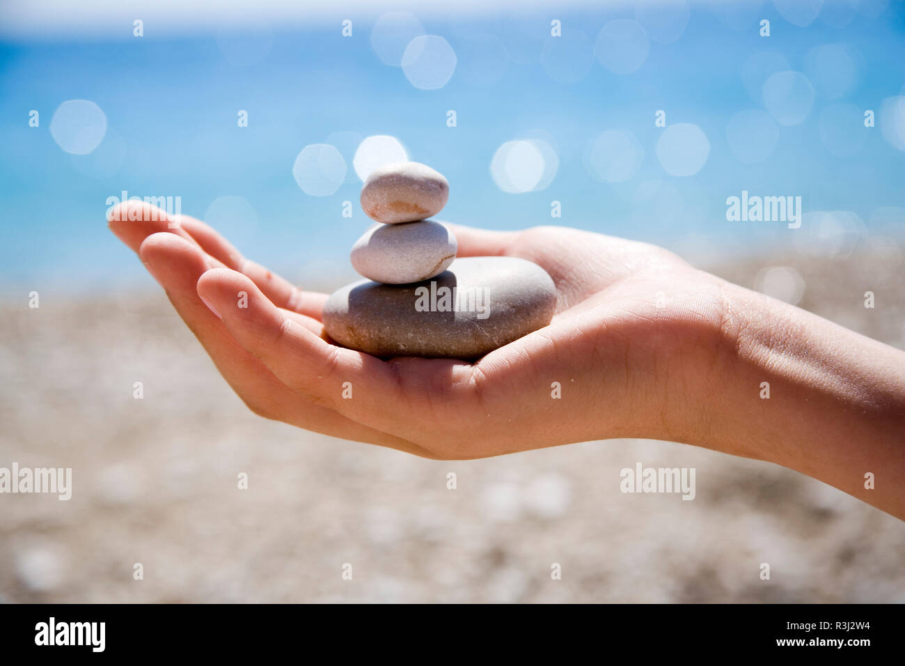 stones in the hand Stock Photo - Alamy