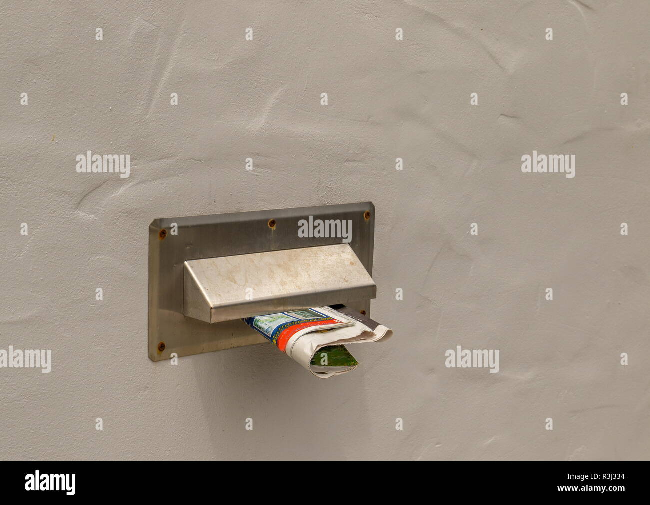 Junk mail hand delivered into a residential letter box image with copy ...