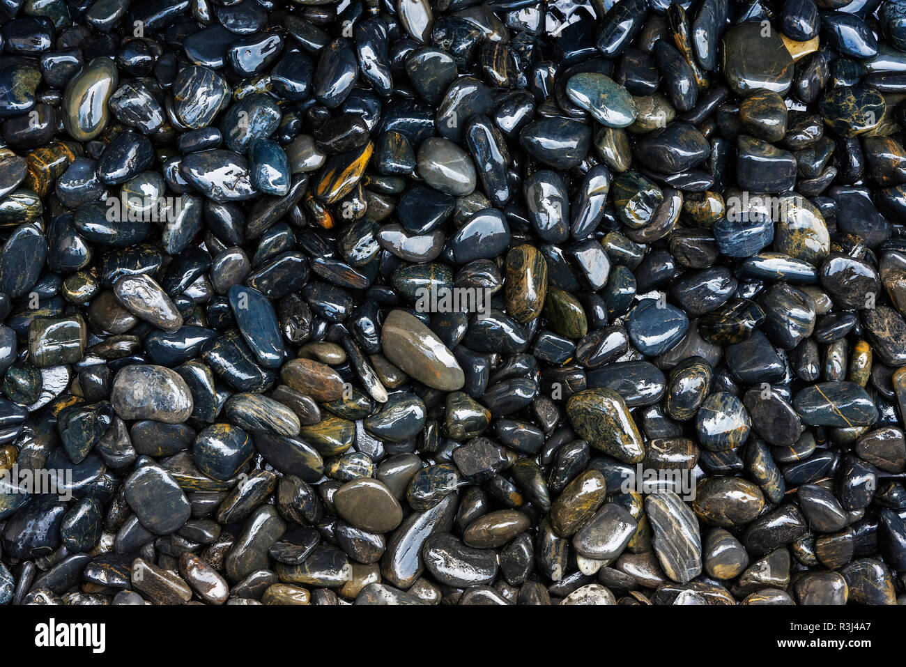 Abstract background from wet black pebbles pattern decoration in garden ...