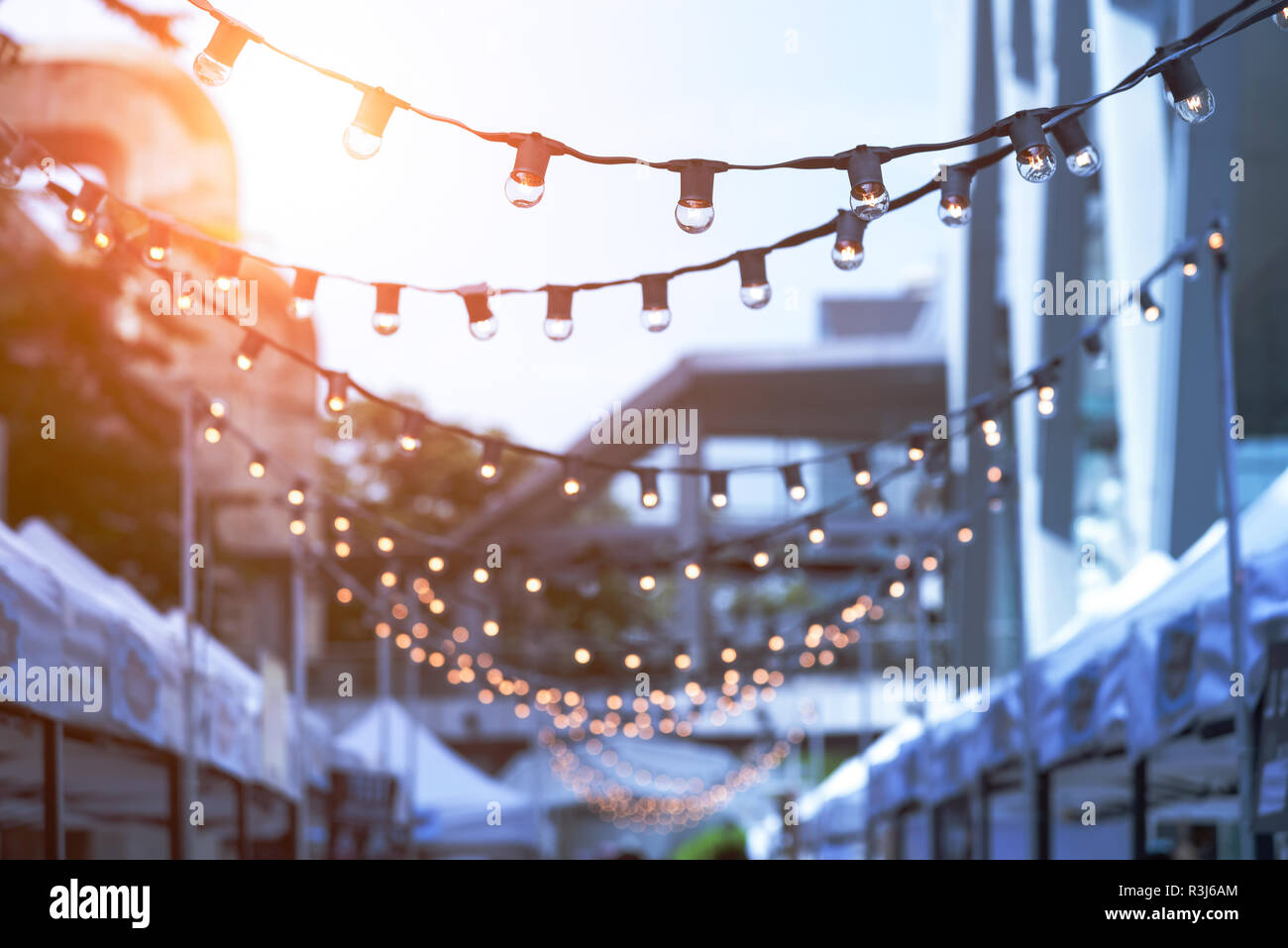 Party string lights hanging in a line on street in Bangkok, Thailand ...