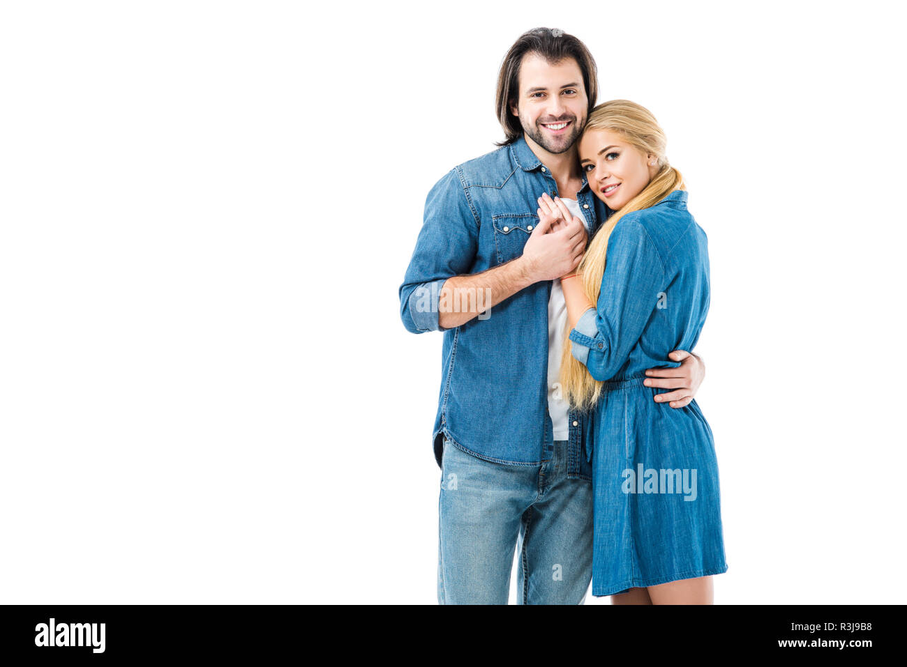 Lovely couple in jeans holding hands and hugging isolated on white ...