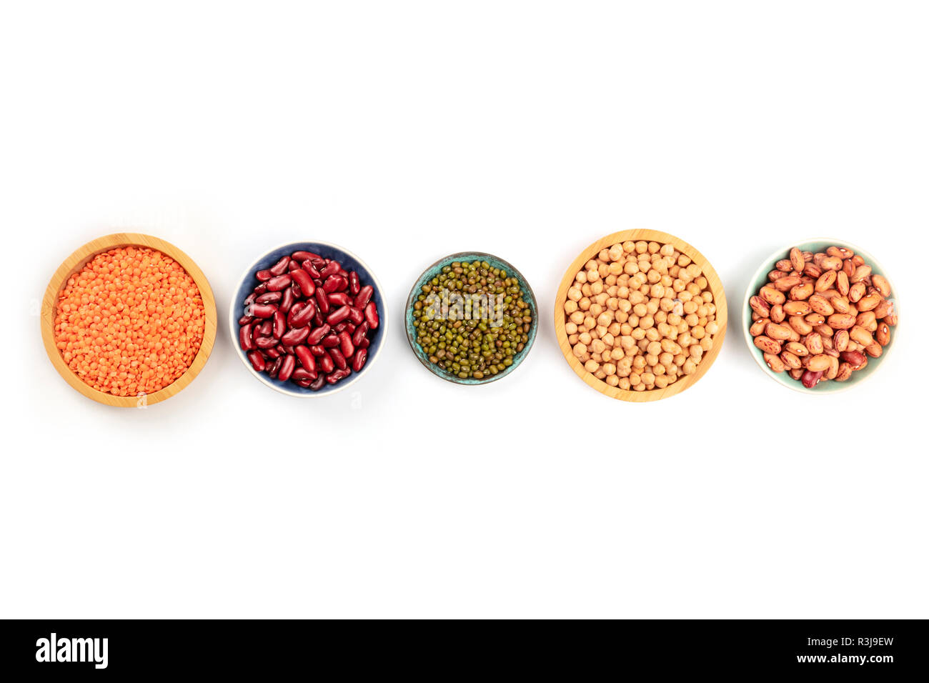 Various types of legumes, shot from above on a white background with ...
