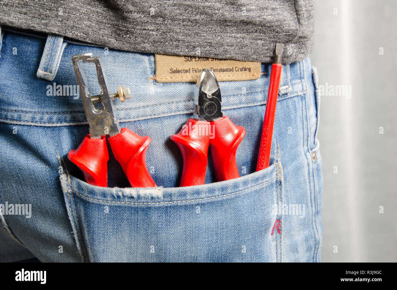 electrician tool in the trouser pocket Stock Photo - Alamy