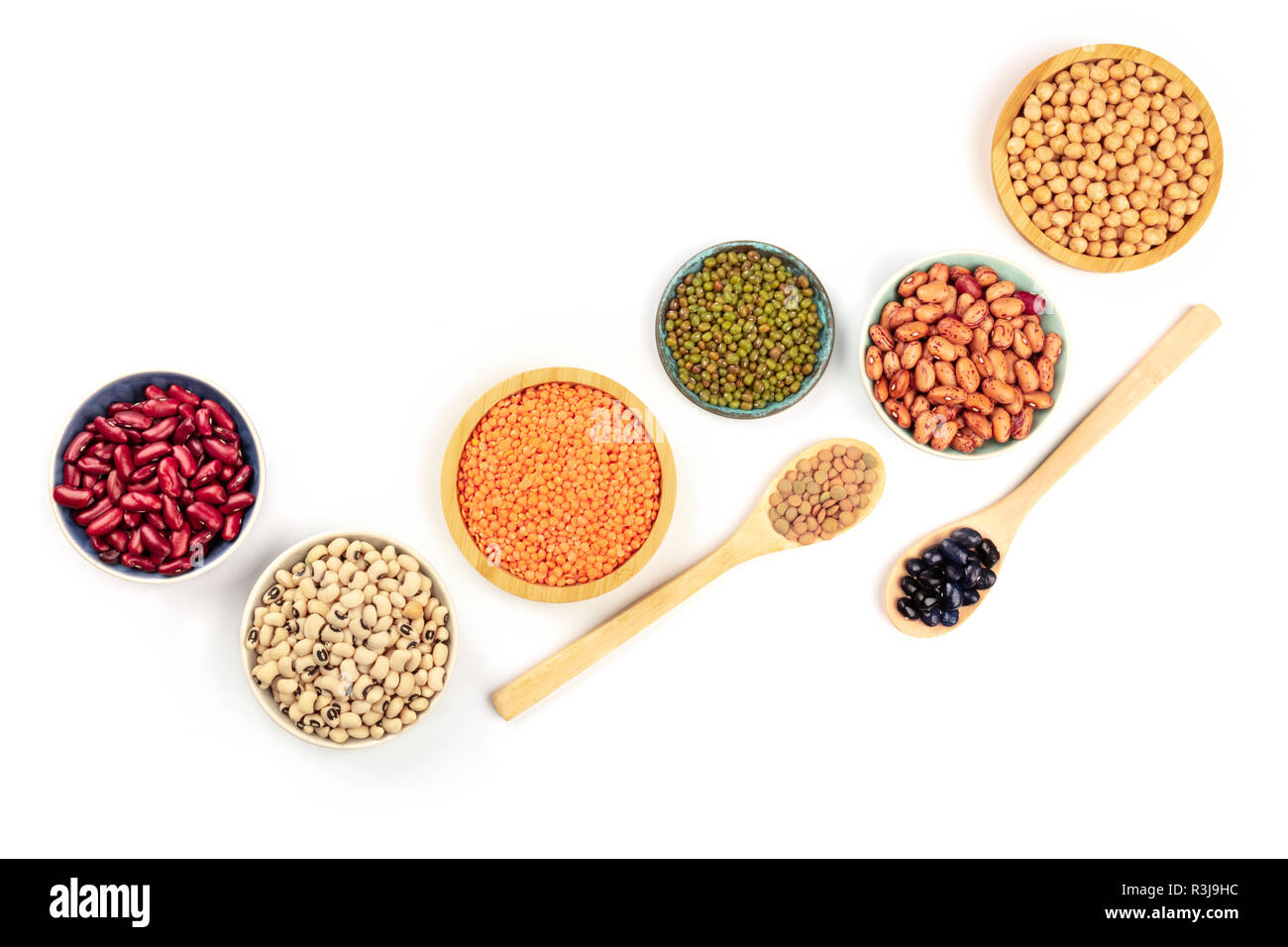 Various types of legumes, shot from above on a white background with ...