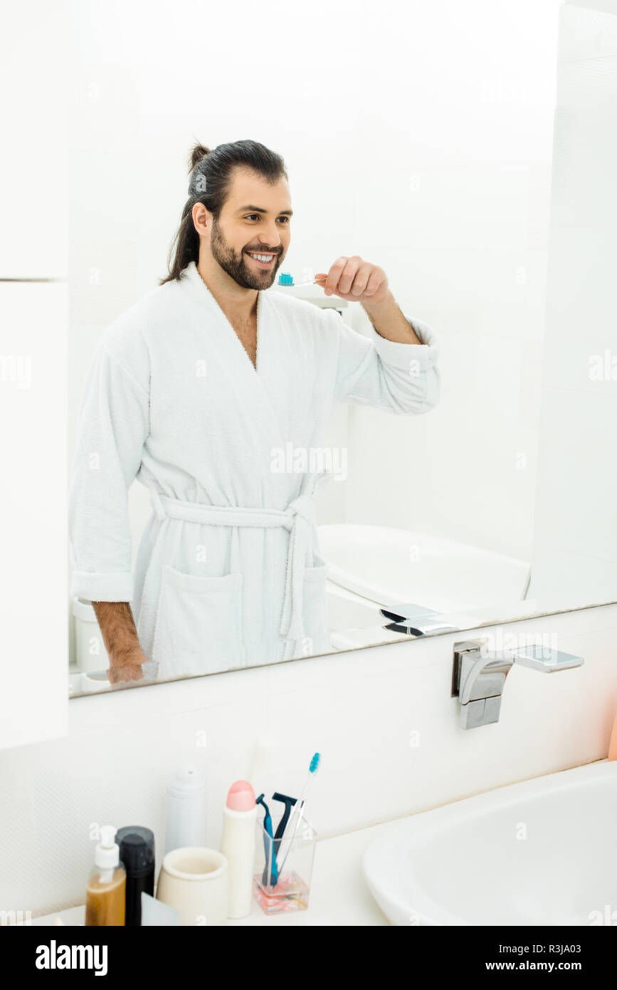 handsome adult man brushing teeth in bathroom Stock Photo - Alamy