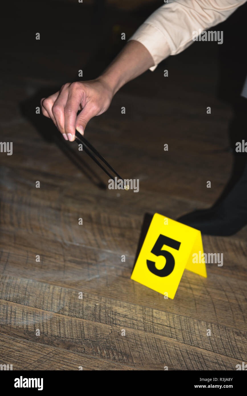 cropped view of hand examining evidence at crime scene Stock Photo - Alamy