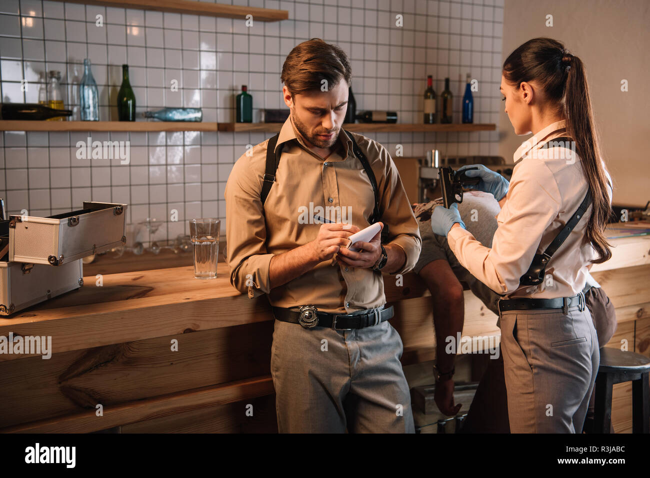 Female And Male Detectives Collecting Evidence And Investigating Dead