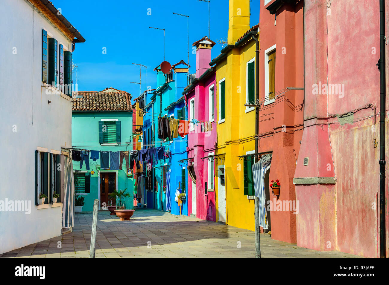 Colorful houses near canal on Burano island, Venice, Italy. Burano is a ...