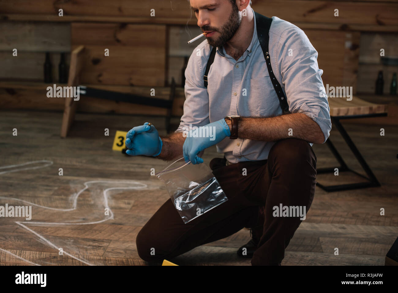 smoking male detective collecting evidence at crime scene Stock Photo ...