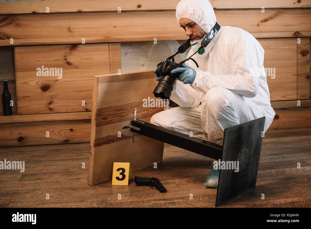 forensic investigator documenting evidence with camera at crime scene ...