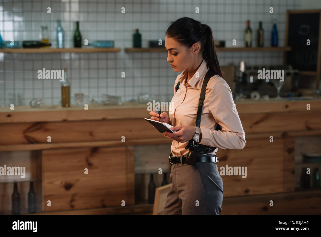 female detective taking notes on a crime scene Stock Photo - Alamy