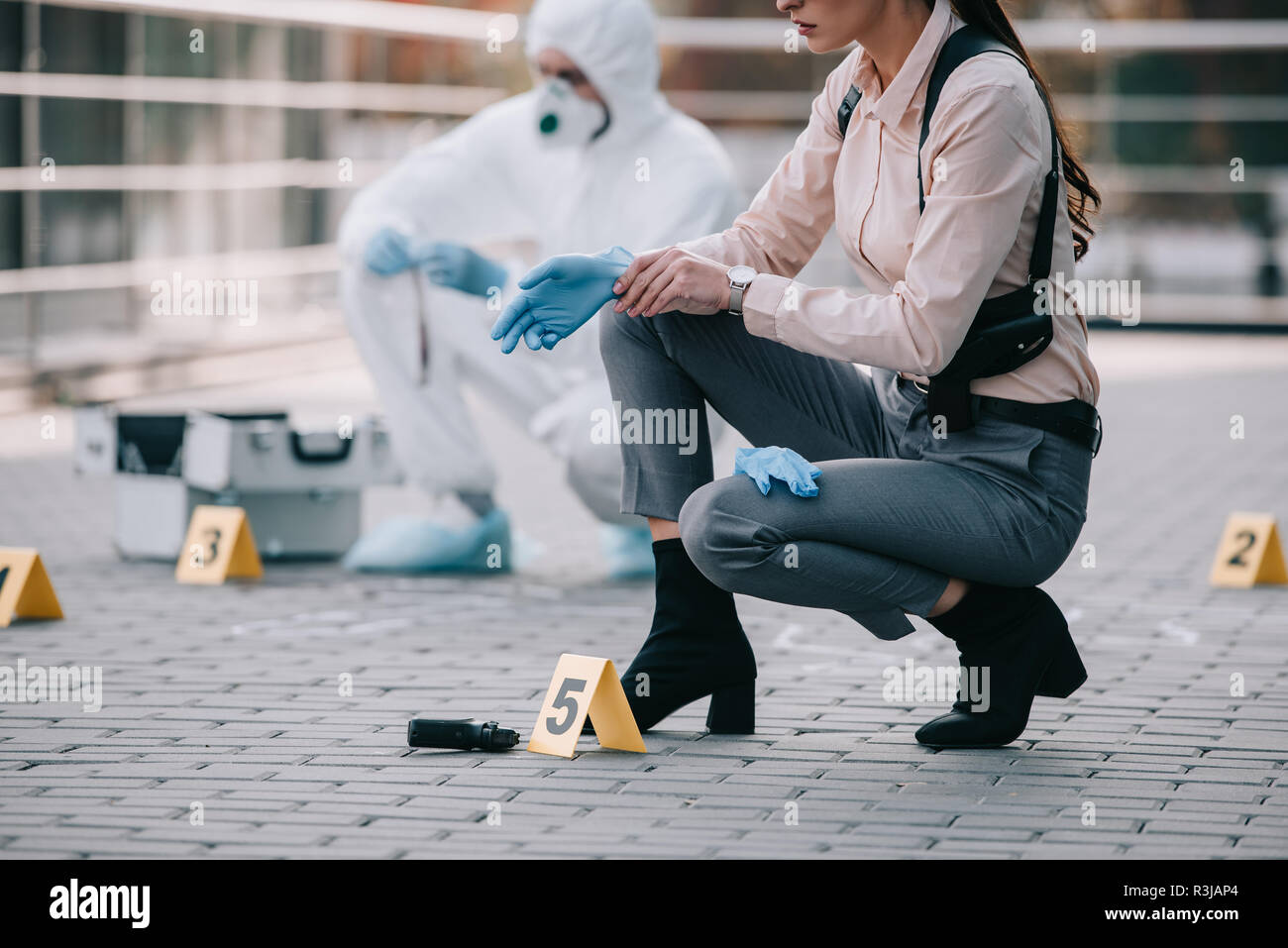 Cropped View Of Female Detective Wearing Latex Gloves With