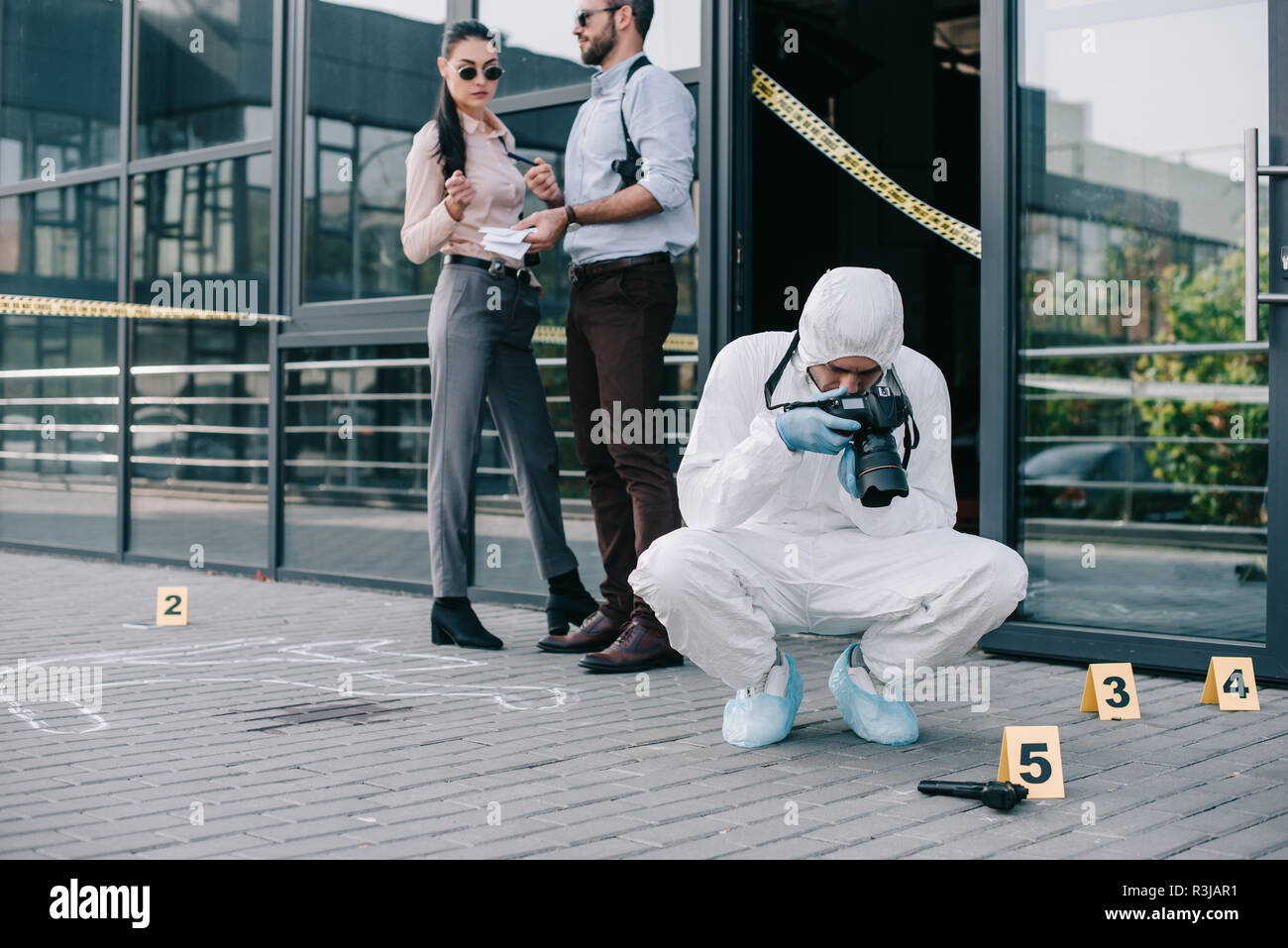 criminologist making photo at crime scene Stock Photo - Alamy