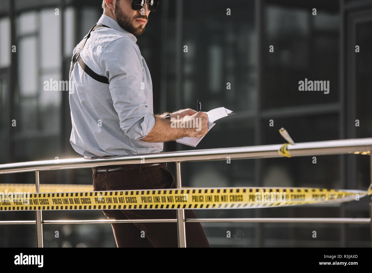 male detective in sunglasses making notes Stock Photo - Alamy