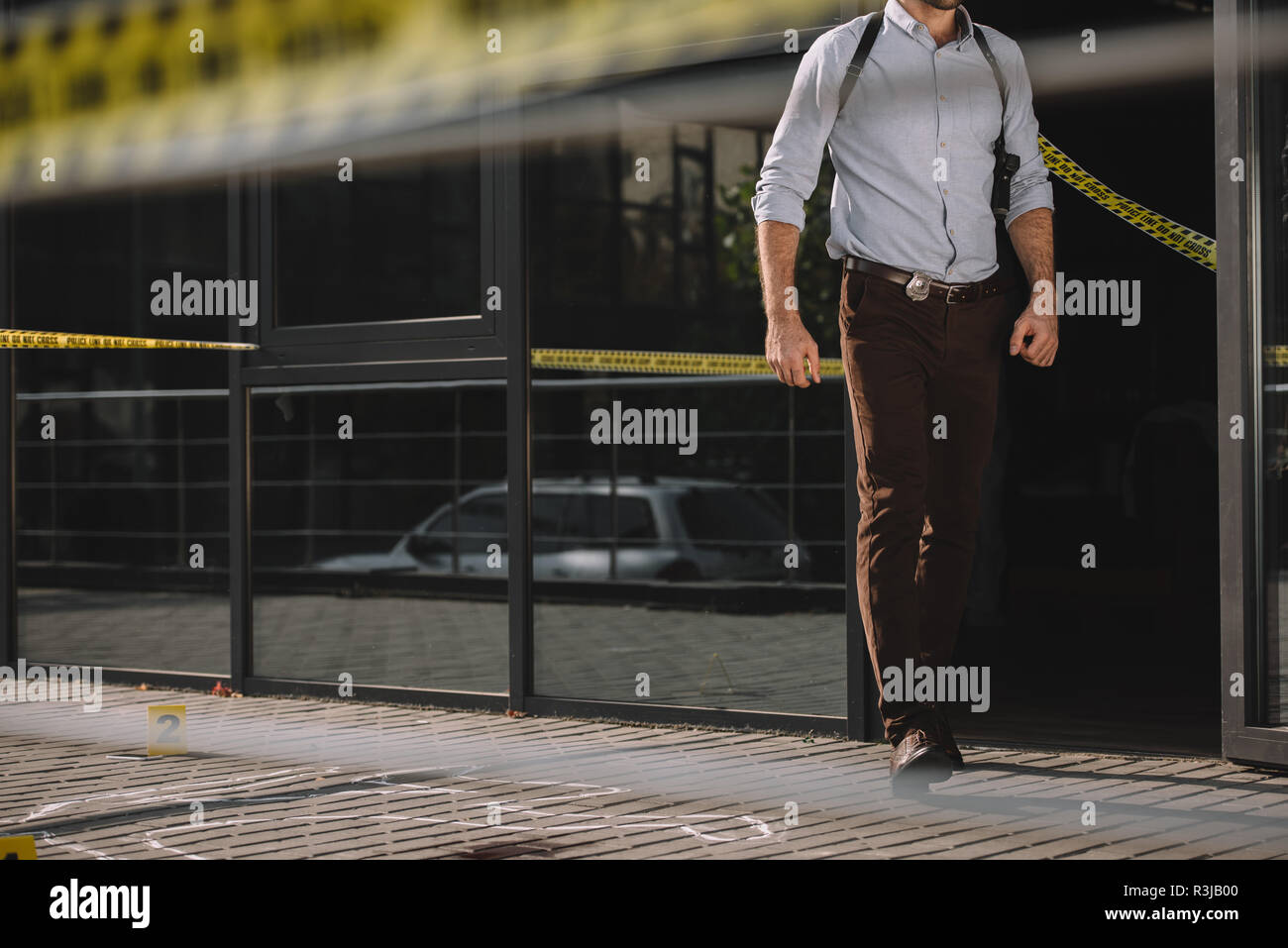 cropped view of male detective walk through the crime scene Stock Photo ...