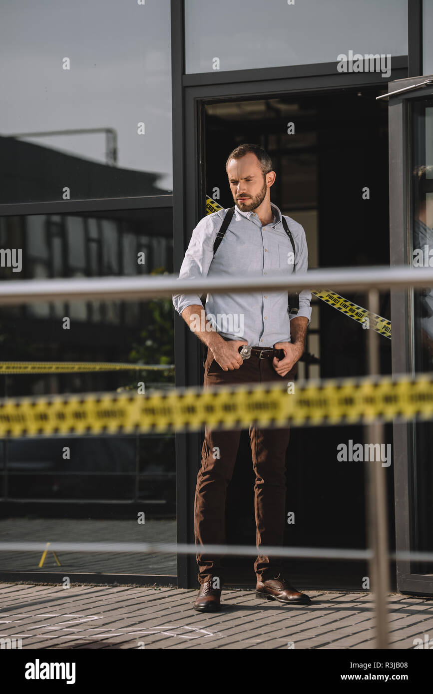 male detective thoughtfully looking at crime scene Stock Photo - Alamy