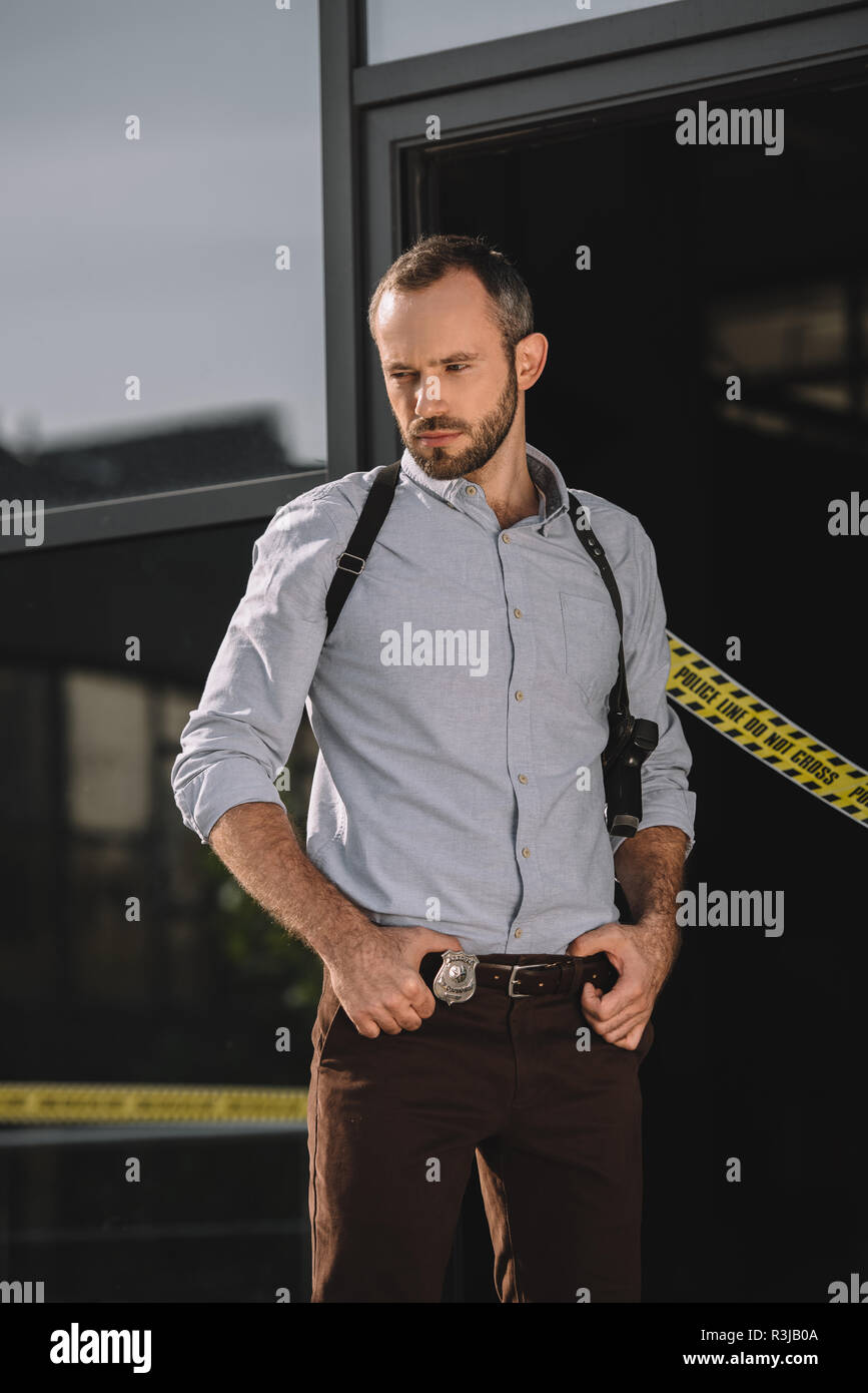 male detective thoughtfully looking at crime scene Stock Photo - Alamy